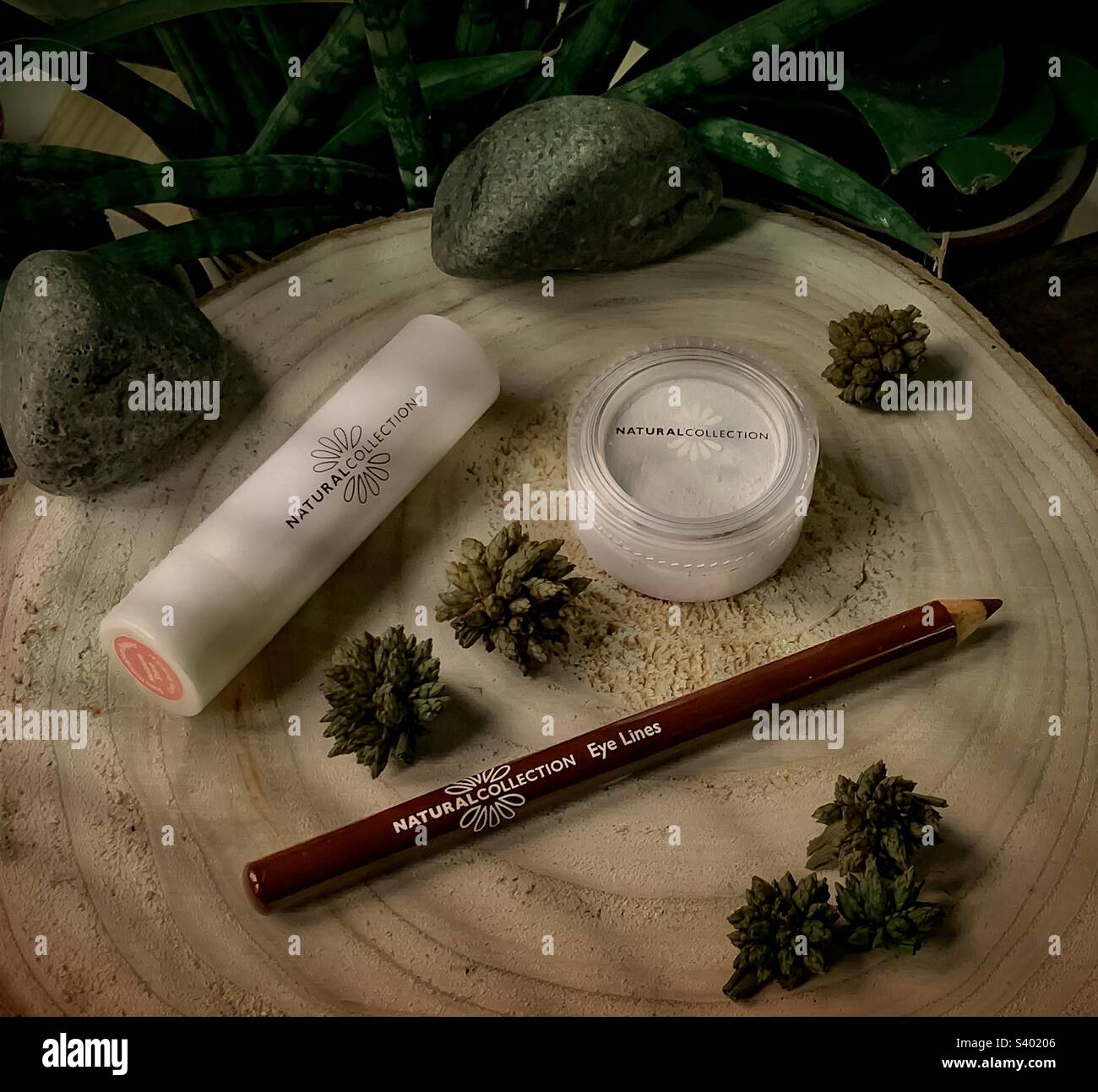 A collection of Boots Natural Collection cosmetics, displayed on wood ...