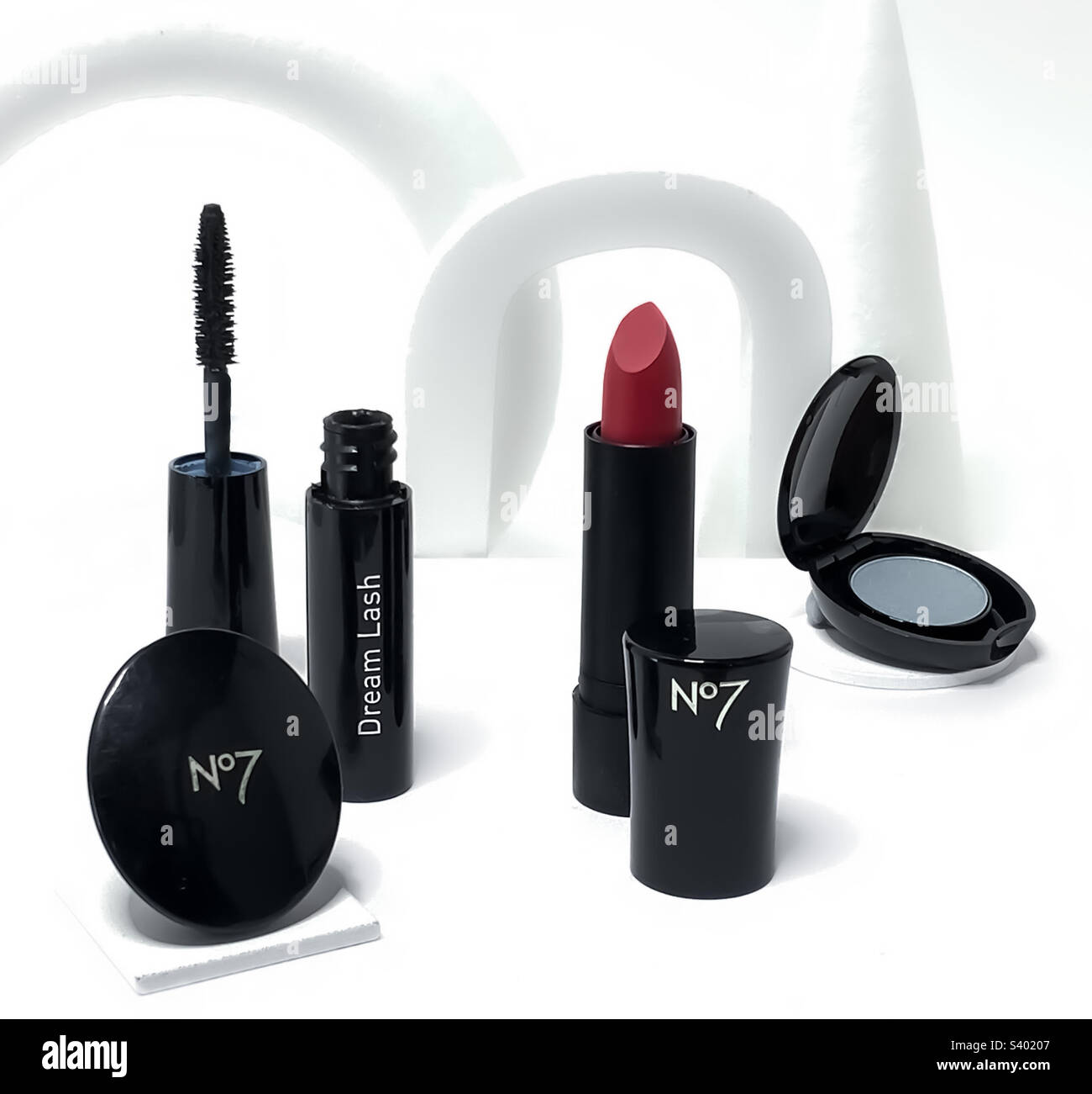 A selection of Boots No7 make up in black cases displayed against a ...