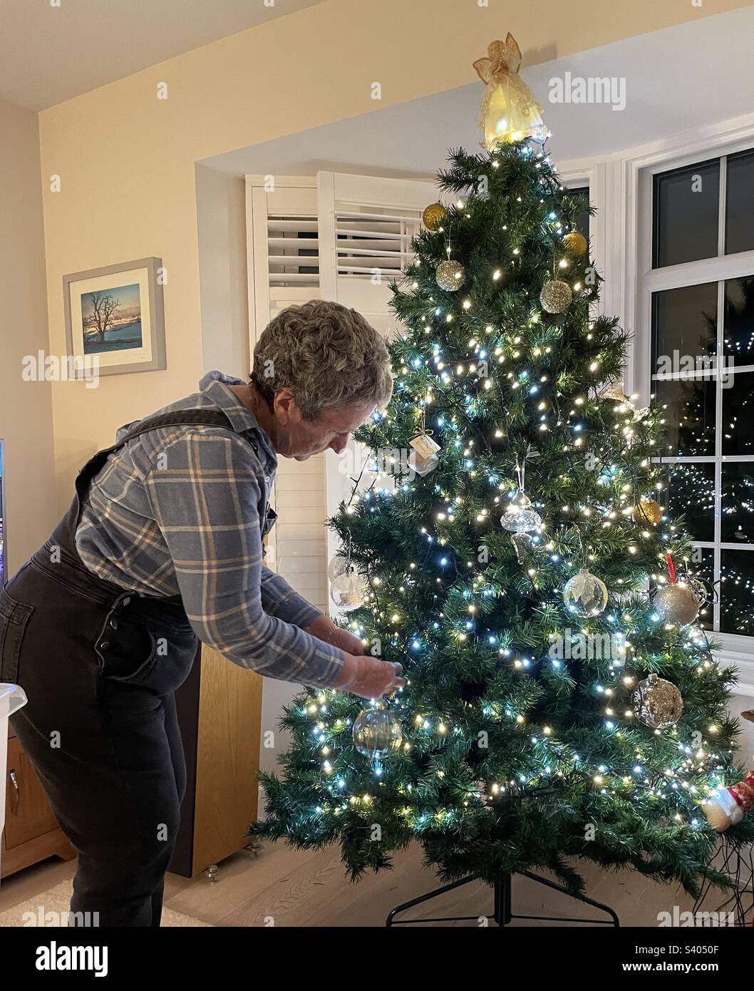 Decorating the family Christmas tree Stock Photo - Alamy