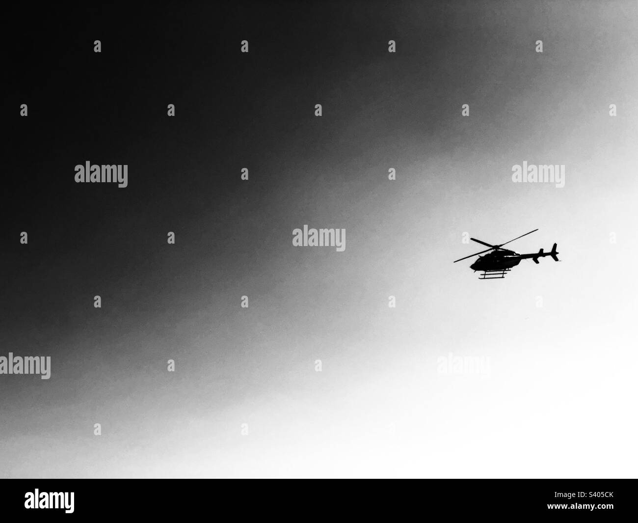 Bell Helicopter at an air show with a cloud free sky and in silhouette ...