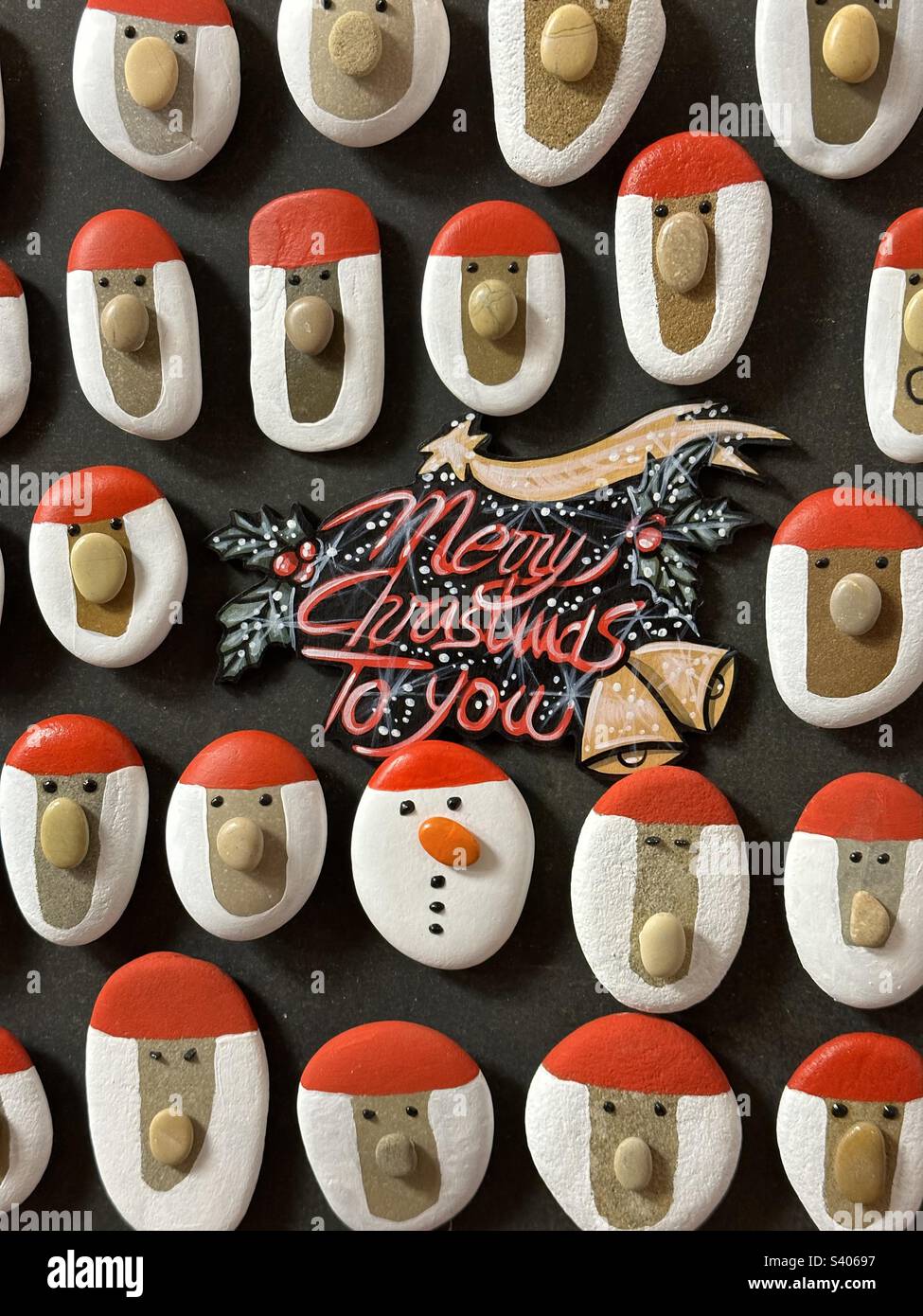 Merry Christmas with many Santa Claus made of stones at the Christmas ...
