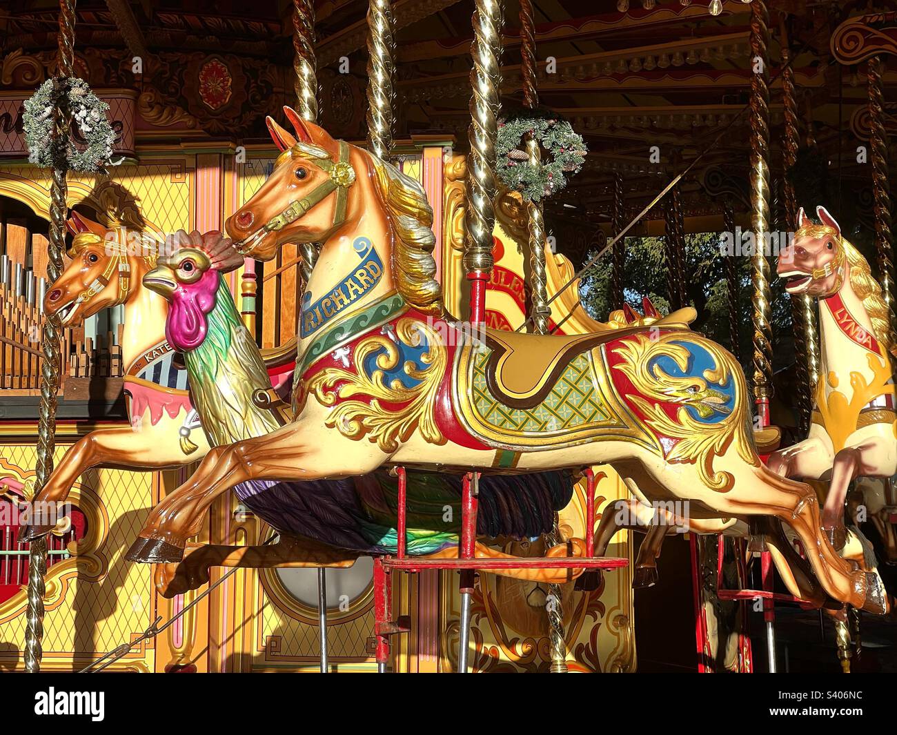 Merry-go-round, carousel horses and chicken in the sun Stock Photo - Alamy