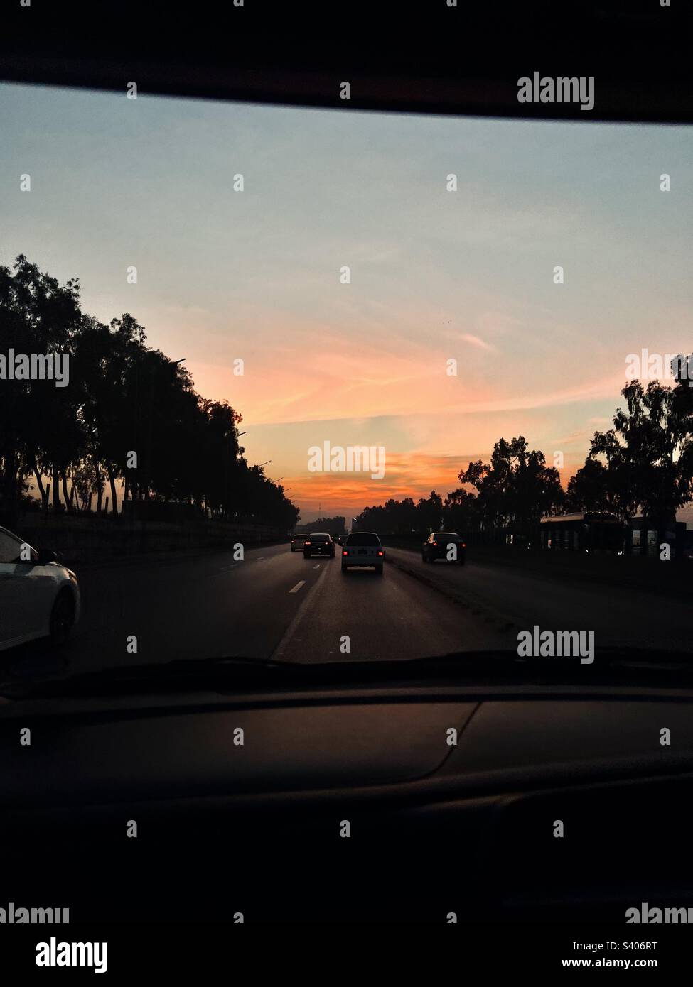 Evening silhouette of sun setting, on the highway in Islamabad Pakistan ...