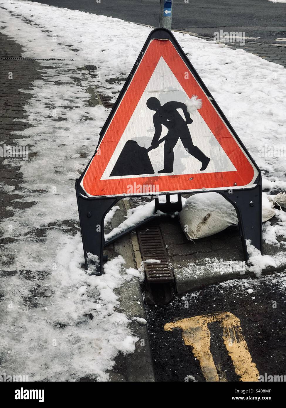 British road triangle warning sign in the trampled snow Stock Photo - Alamy