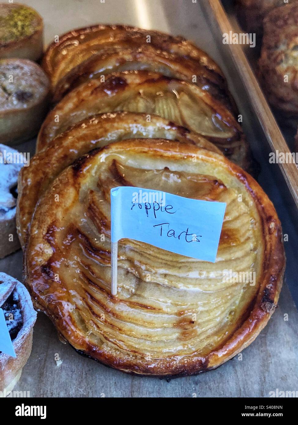 Apple tart in bakery shop window Stock Photo - Alamy