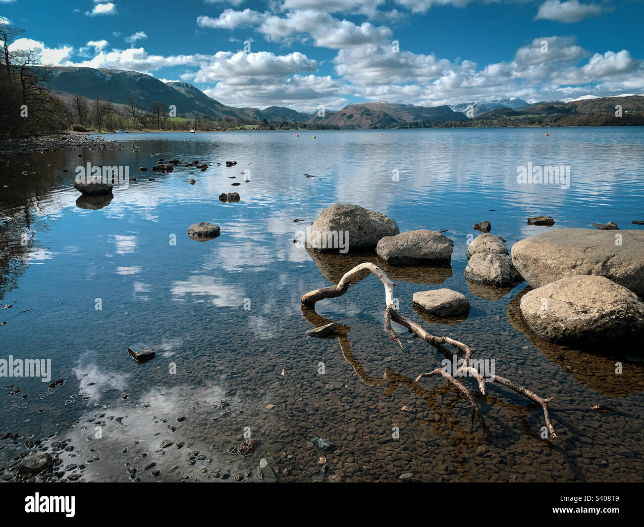 Looking across Ullswater to a sprinkling of snow on the hilltops on a ...