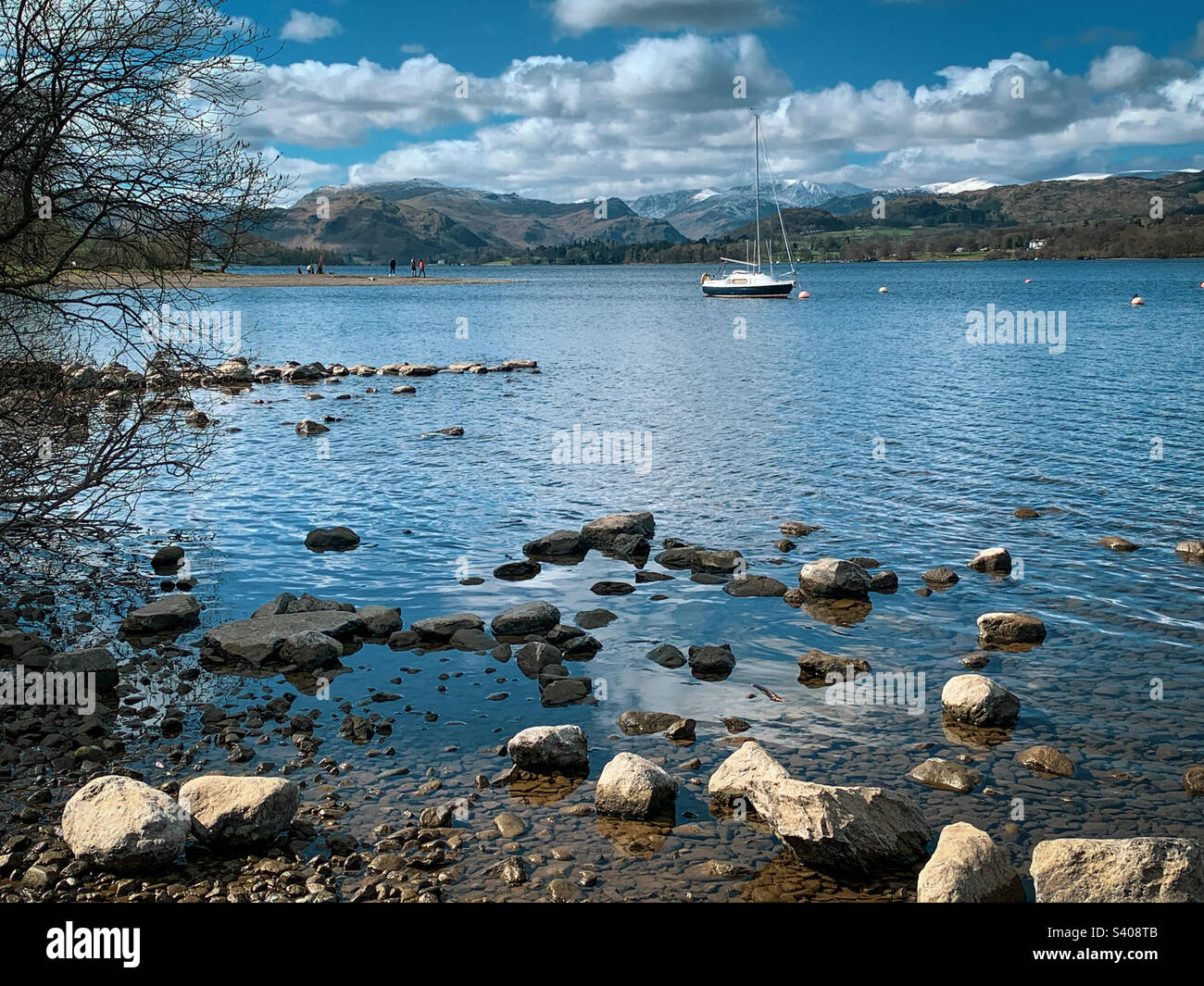 Looking across Ullswater to a sprinkling of snow on the hilltops on a ...