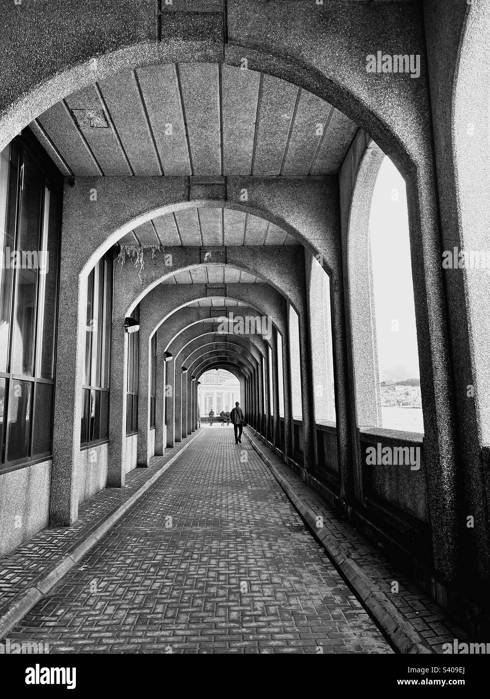 Path through a long colonnade Stock Photo - Alamy