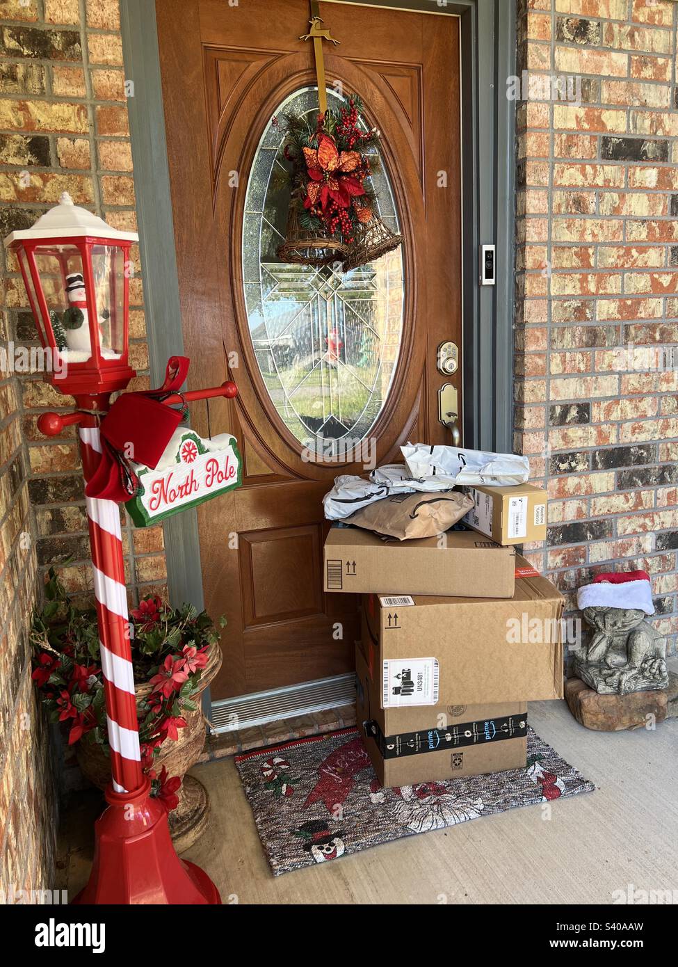 Amazon packages at the front door with Christmas decorations on the ...