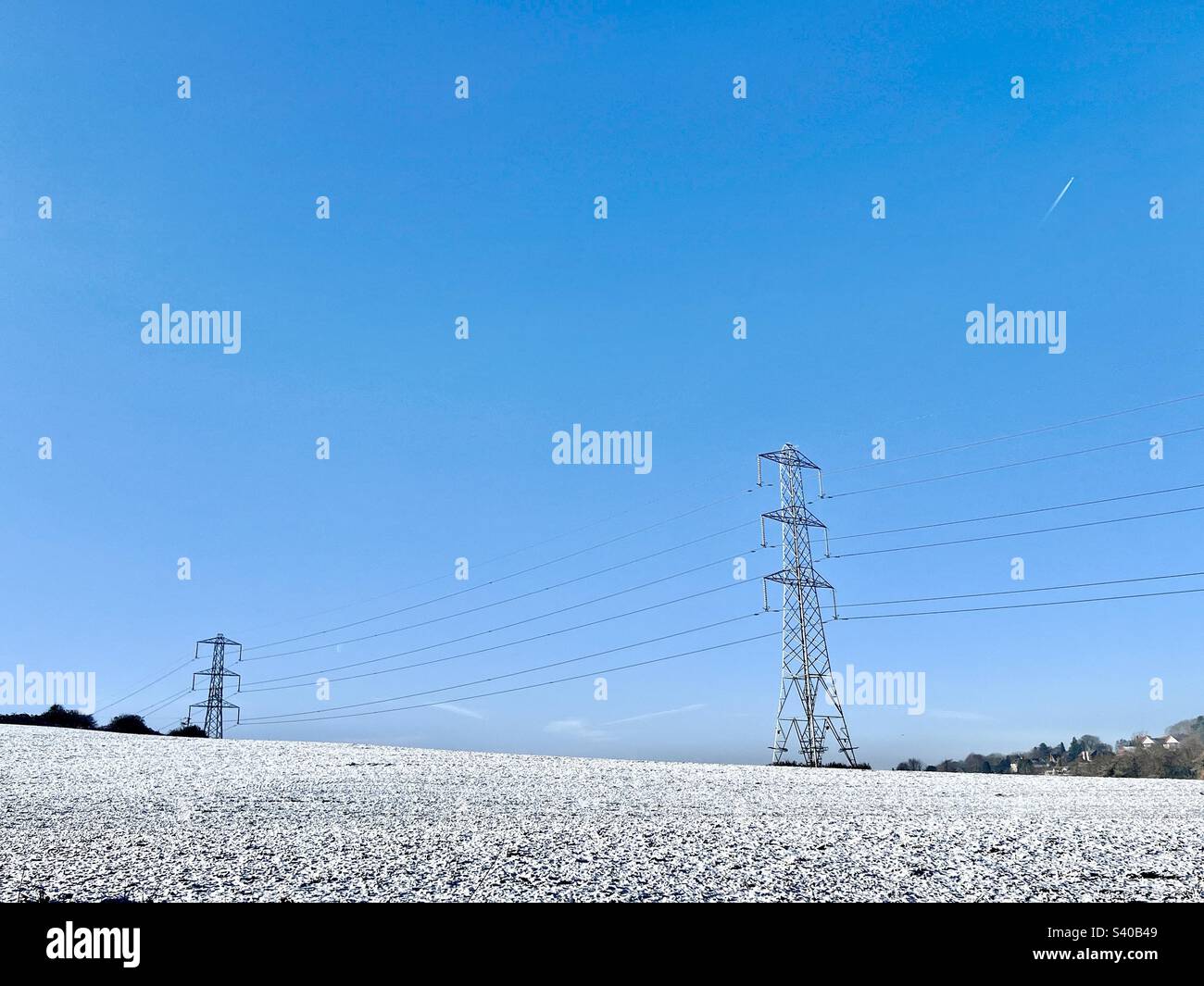 Frozen field covered with snow on a bright and clear December day with ...