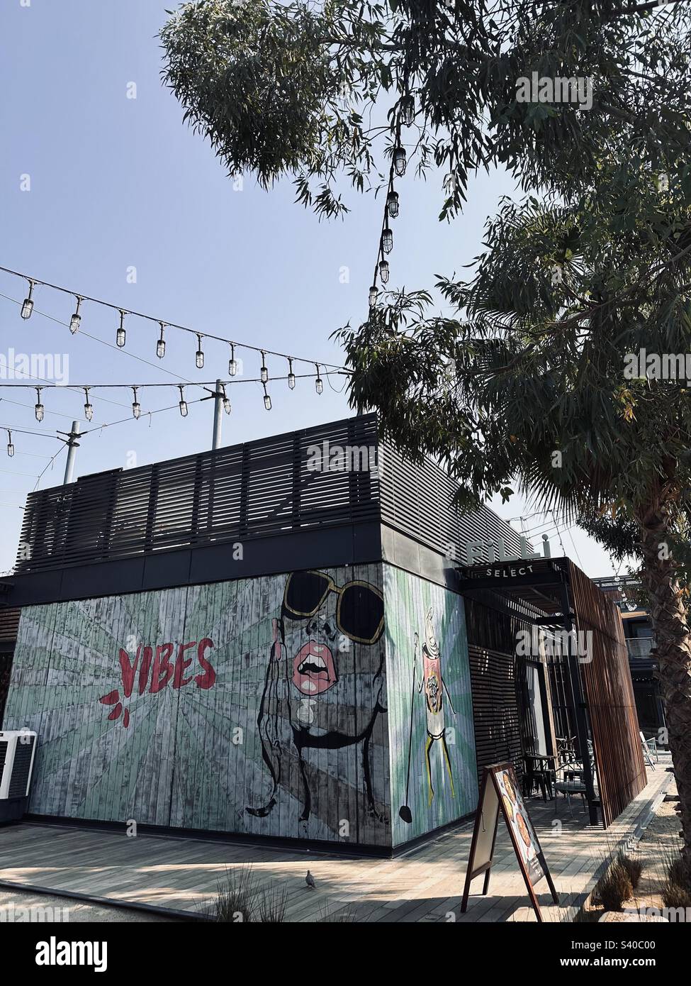 A building covered with a wall mural - Vibes! Stock Photo - Alamy