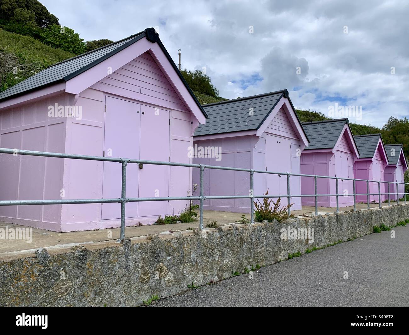 A Row of Pink beach huts, Kent Stock Photo - Alamy