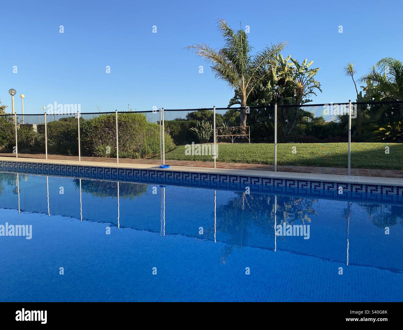 Swimming pool with mesh safety fence Stock Photo - Alamy
