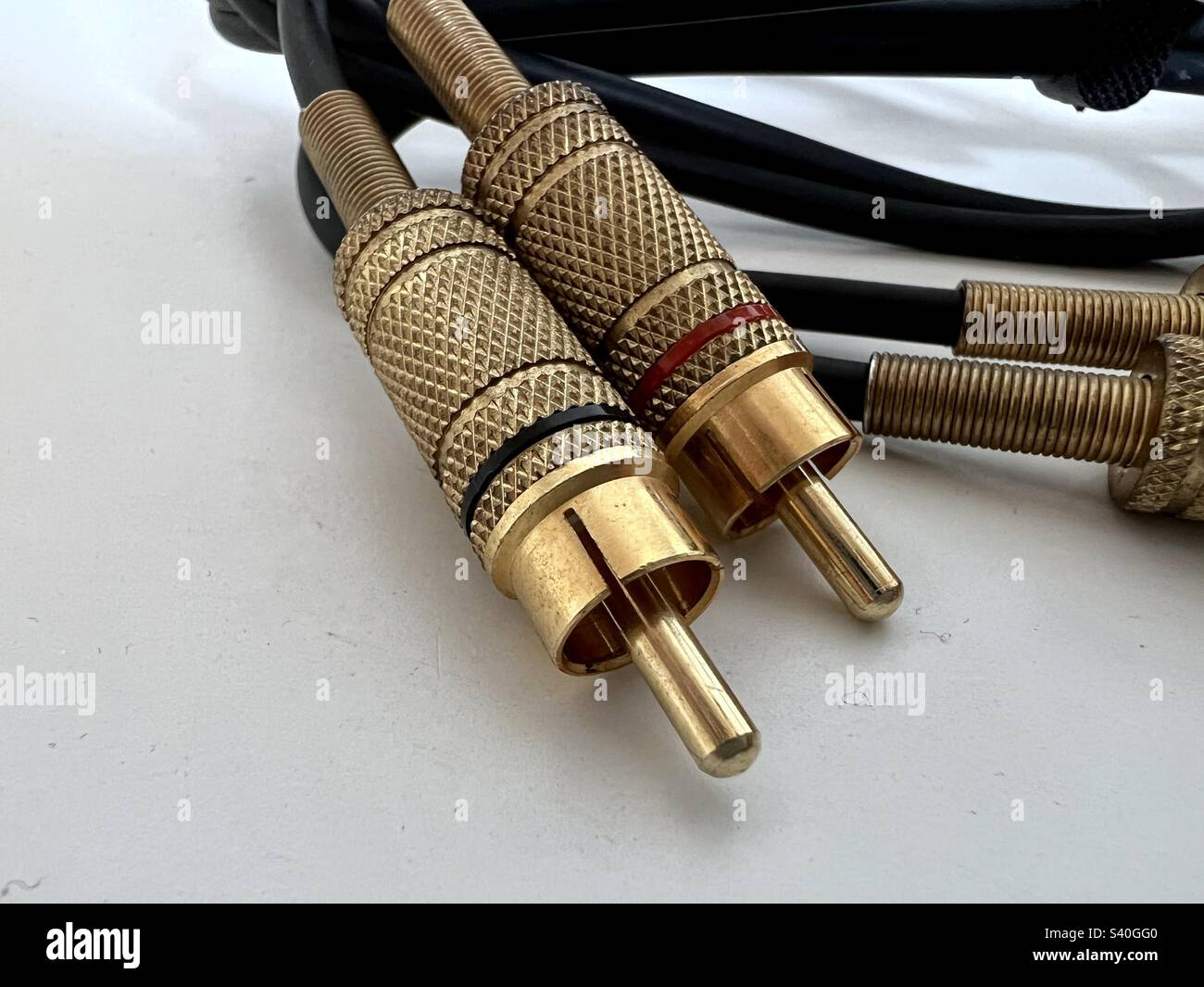 Macro view gold-plated phono connectors at end of black audio cable ...