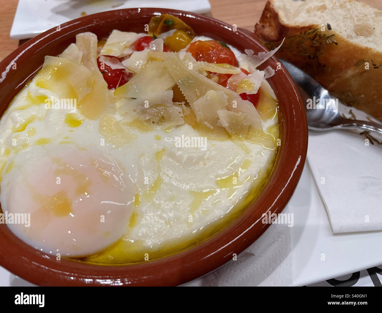 A main dish entrée of stone ground creamy polenta with a poached soft ...