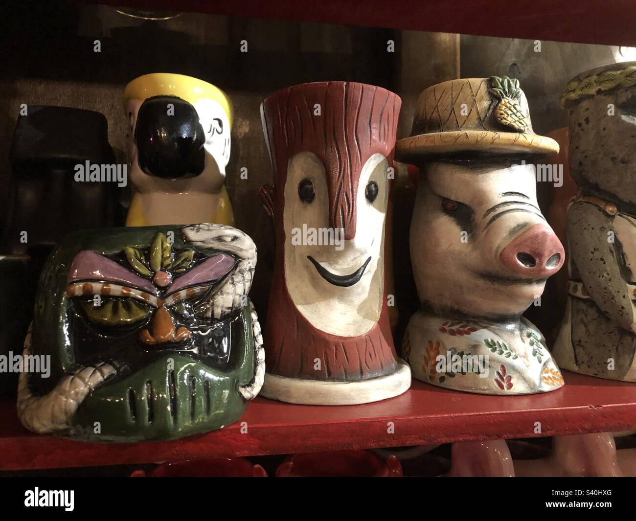 Colorful tiki mug in the shape of animal faces Stock Photo - Alamy