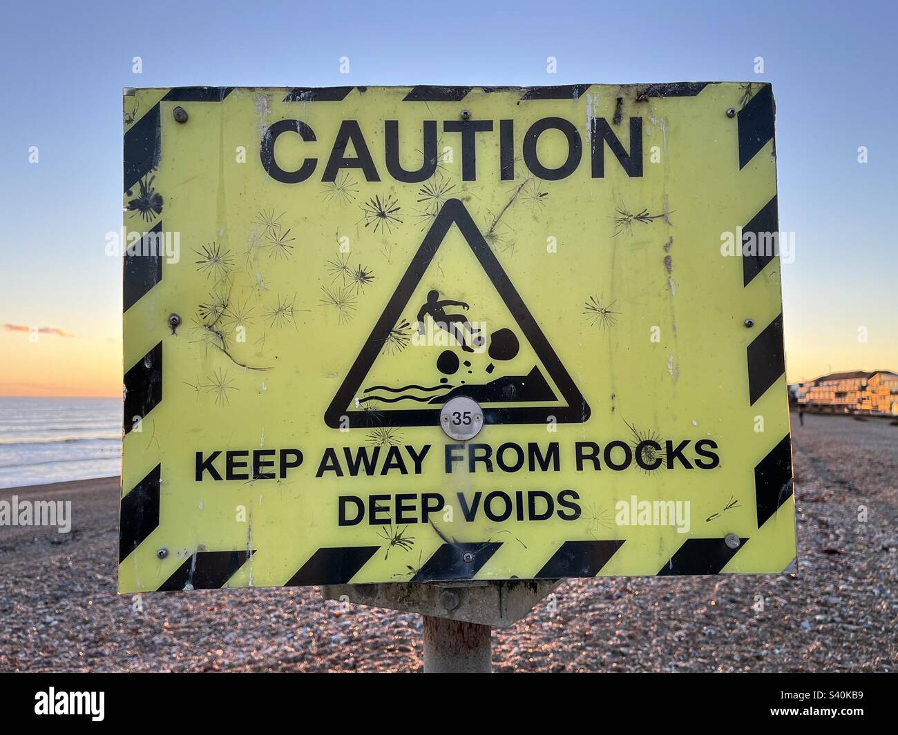 Old caution sign on beach at Lancing, West Sussex, England Stock Photo ...