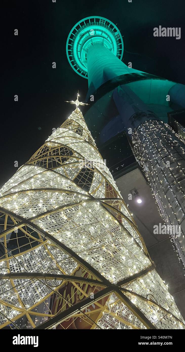 Low angle shot of skytower lit up by lights with a bright light ...