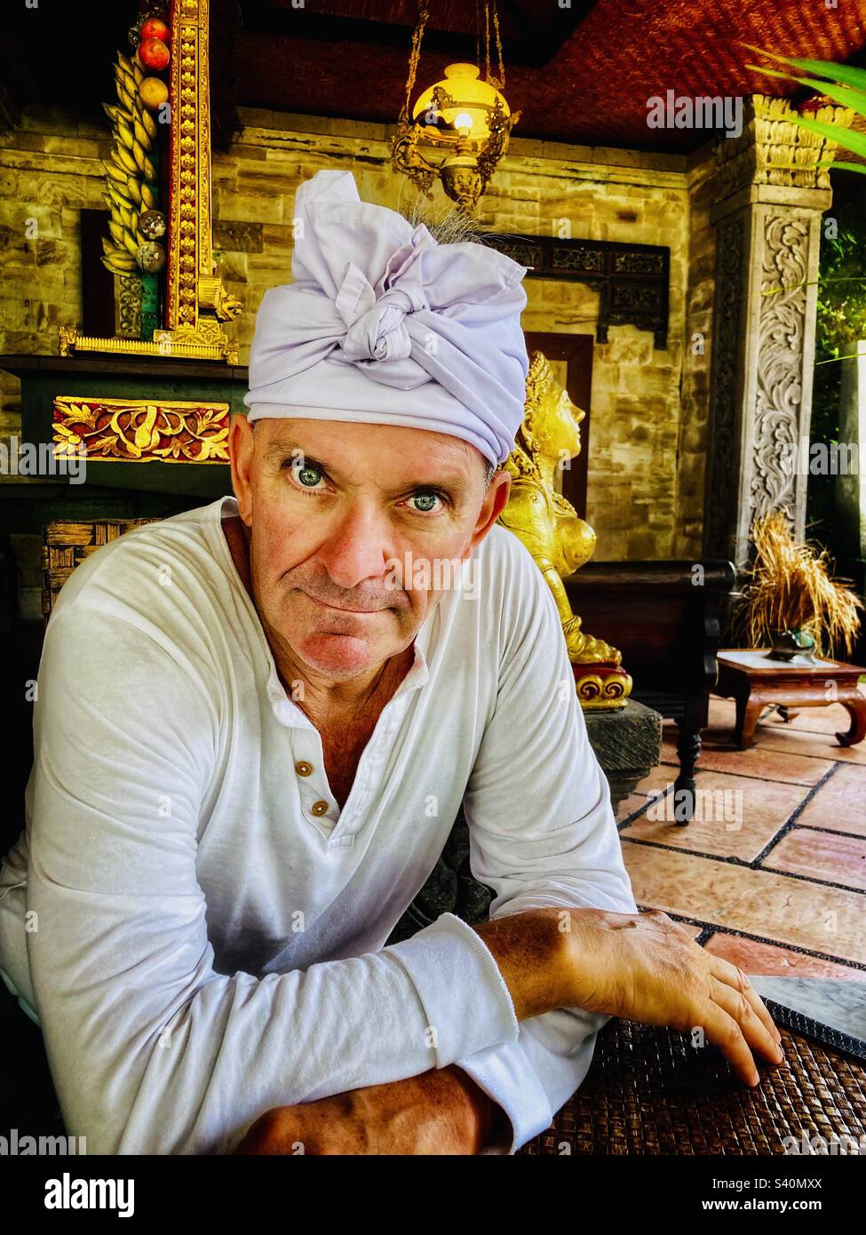 Western man with blue eyes in traditional Balinese head wear Udeng on ...