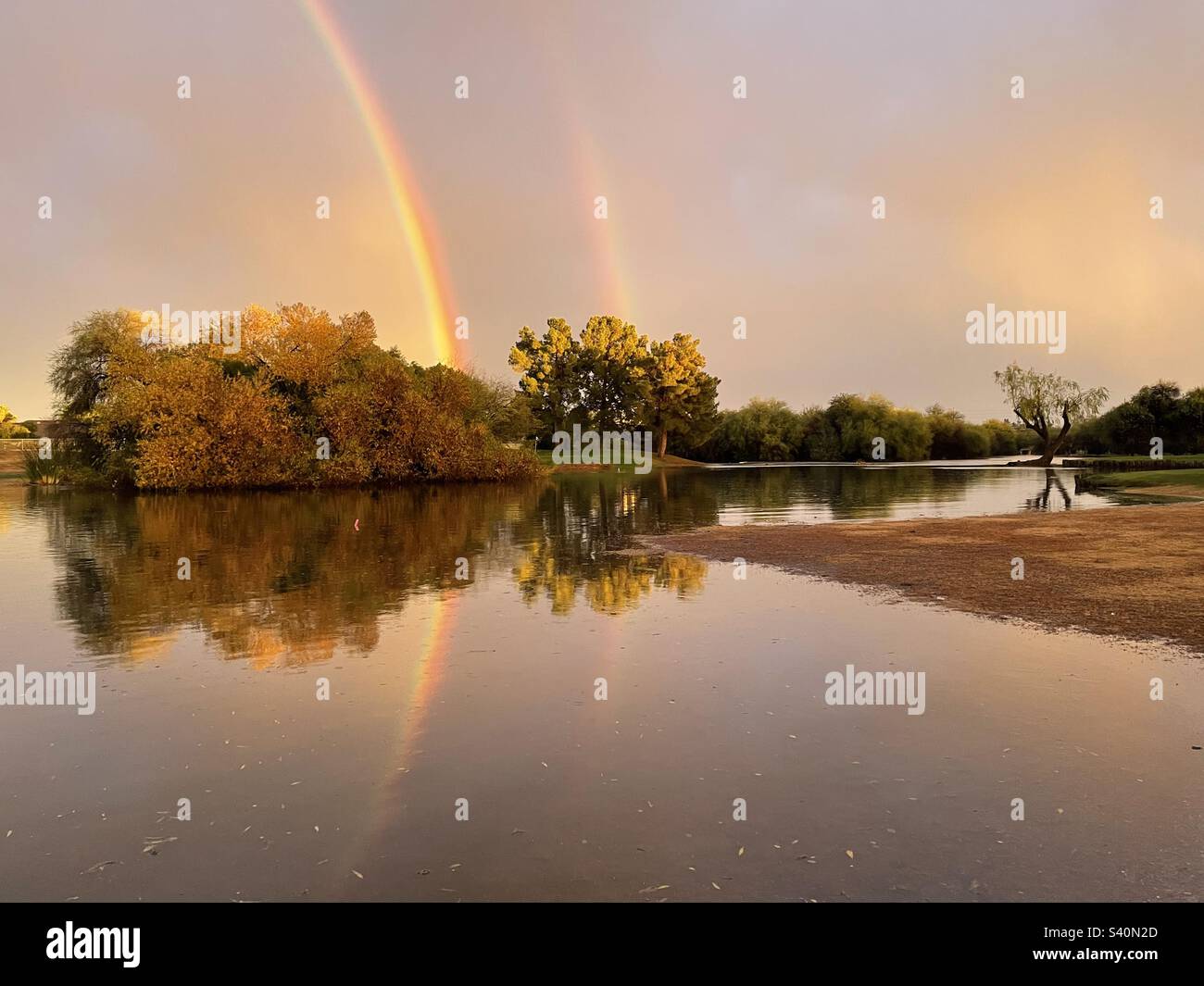 Focusing on double rainbow reflections, shoreline points to center ...