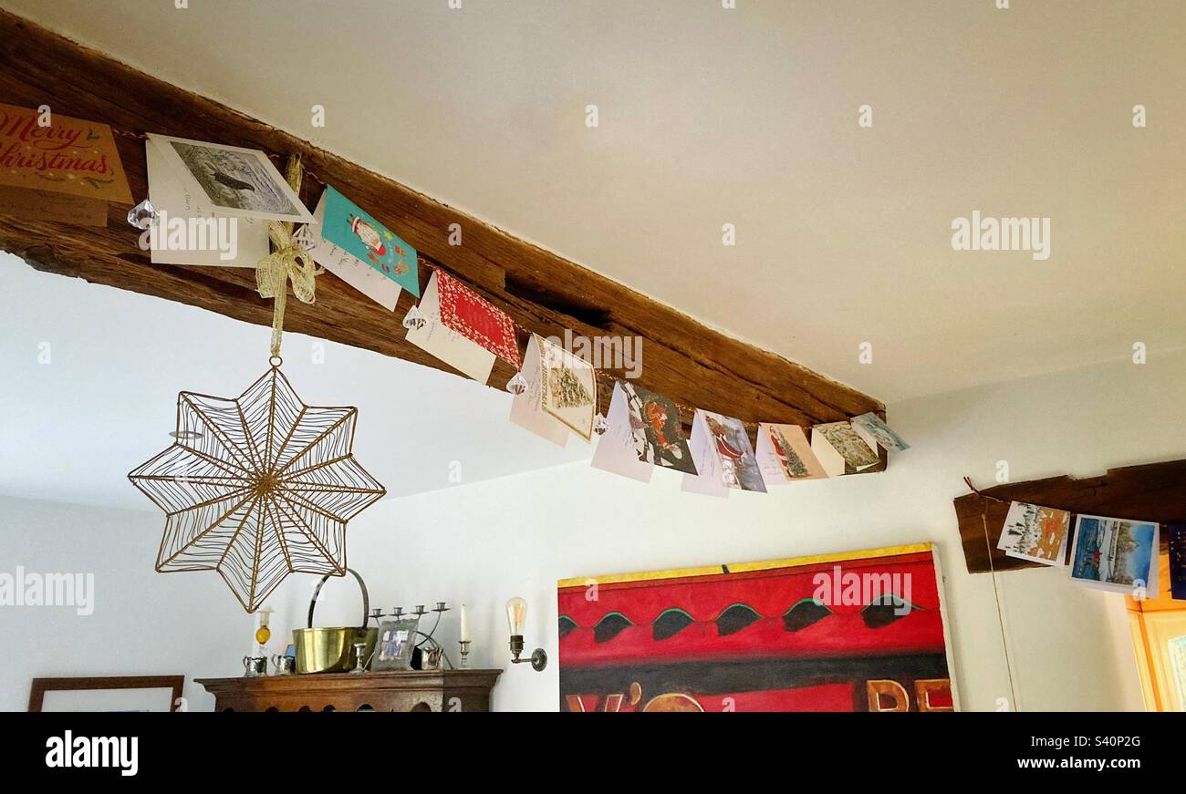 Garlands of Christmas cards hanging on oak beams in a cottage Stock ...