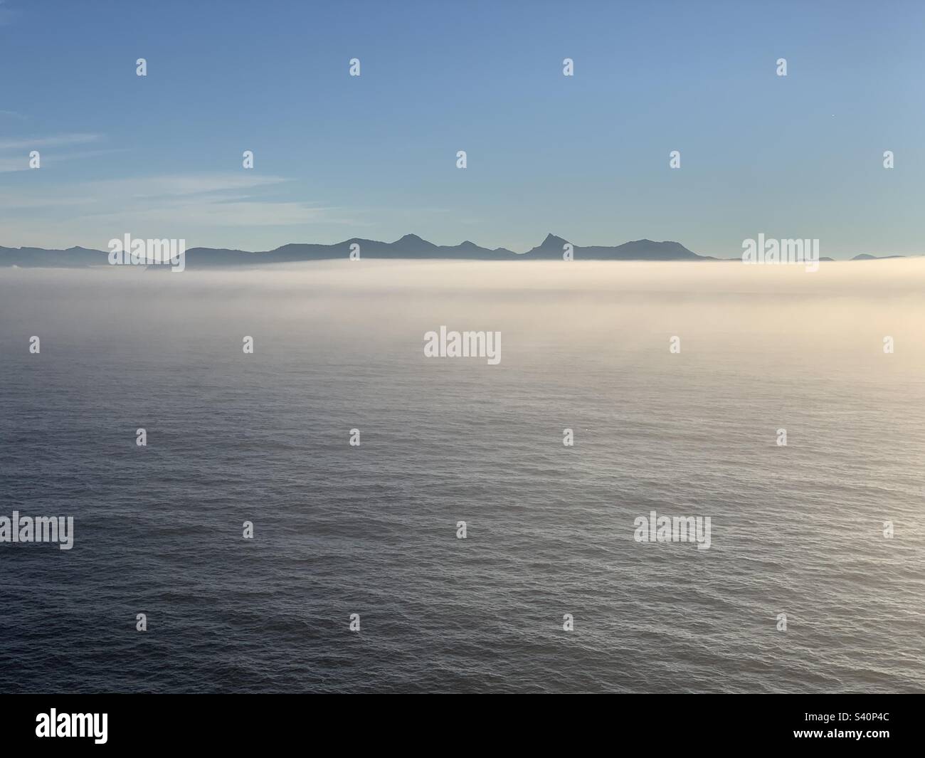 Steam fog over the water seen in the morning during an Alaskan cruise ...
