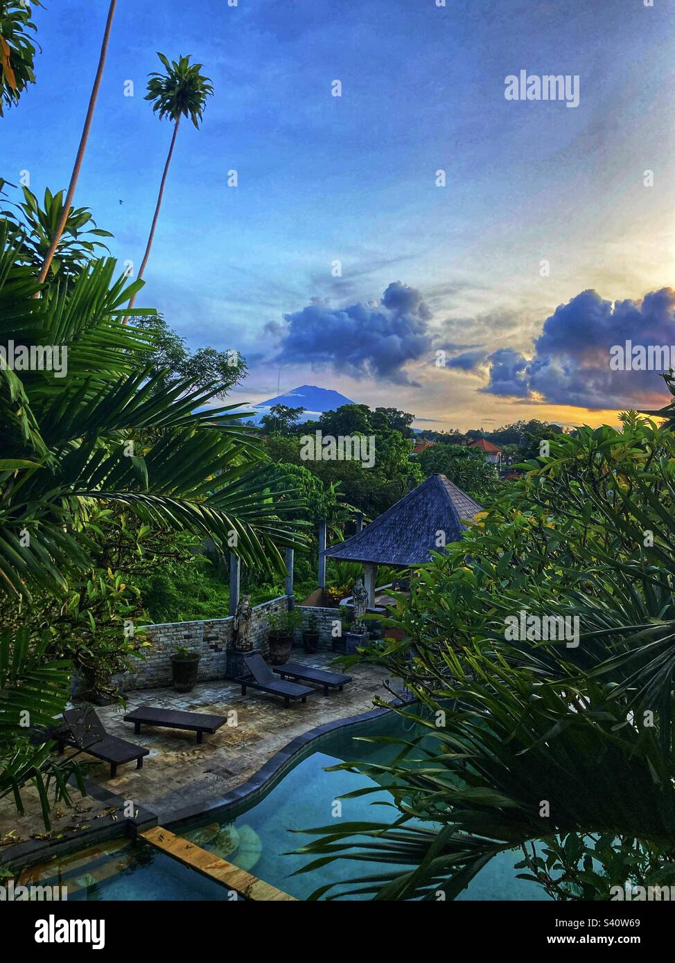 Sunrise fro hotel balcony in Ubud Bali looking over swimming pool and ...