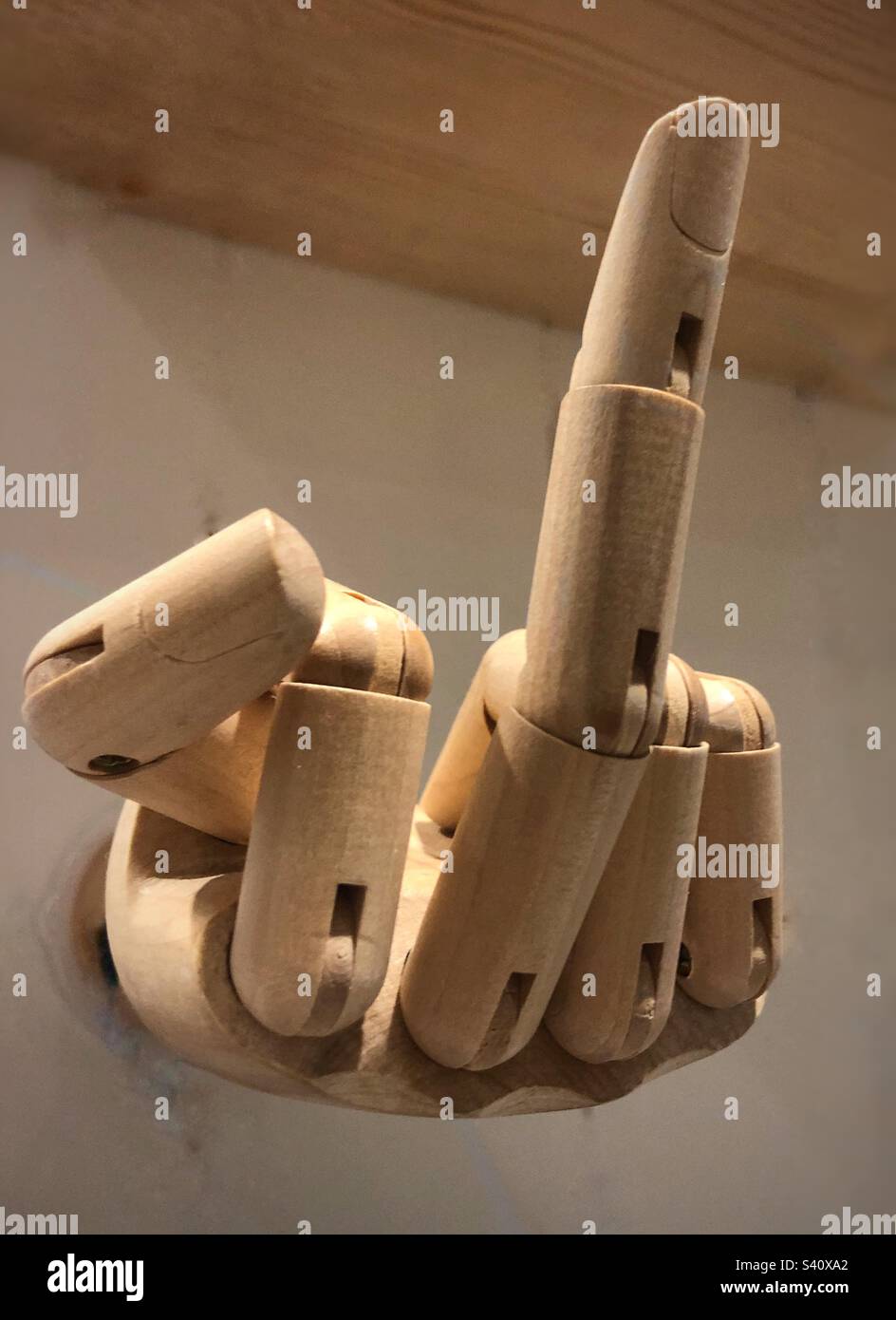Rude hand gesture of a wooden modelling hand Stock Photo - Alamy