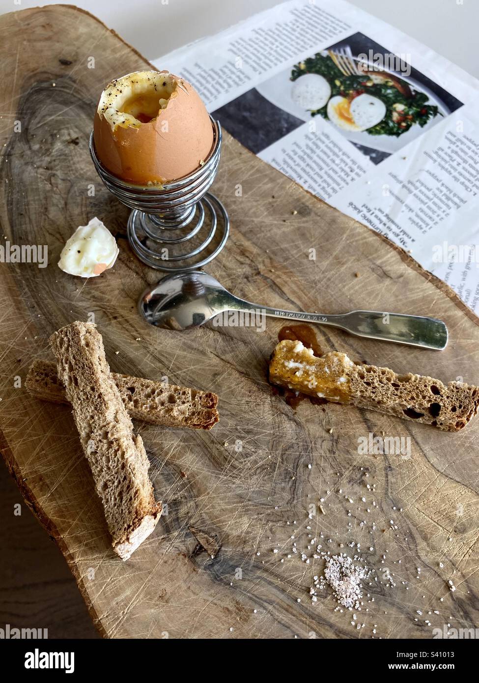 A healthy breakfast composed of a cracked egg with brown bread ...