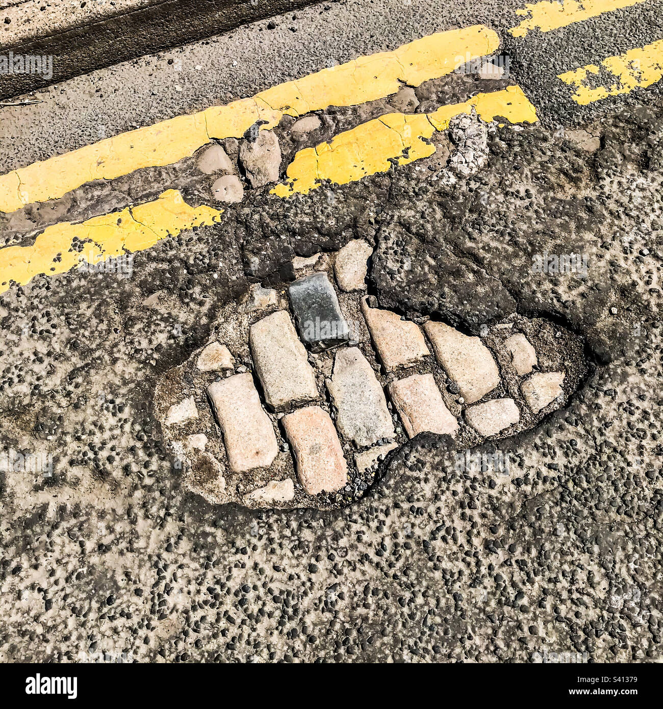 Old cobbled street under newer tarmac Stock Photo - Alamy