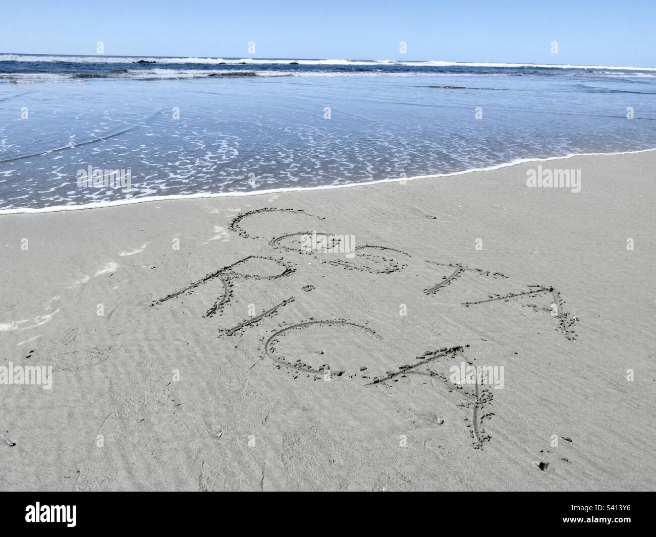 Costa Rica written in the sand next to the water in Nosara Costa Rica ...