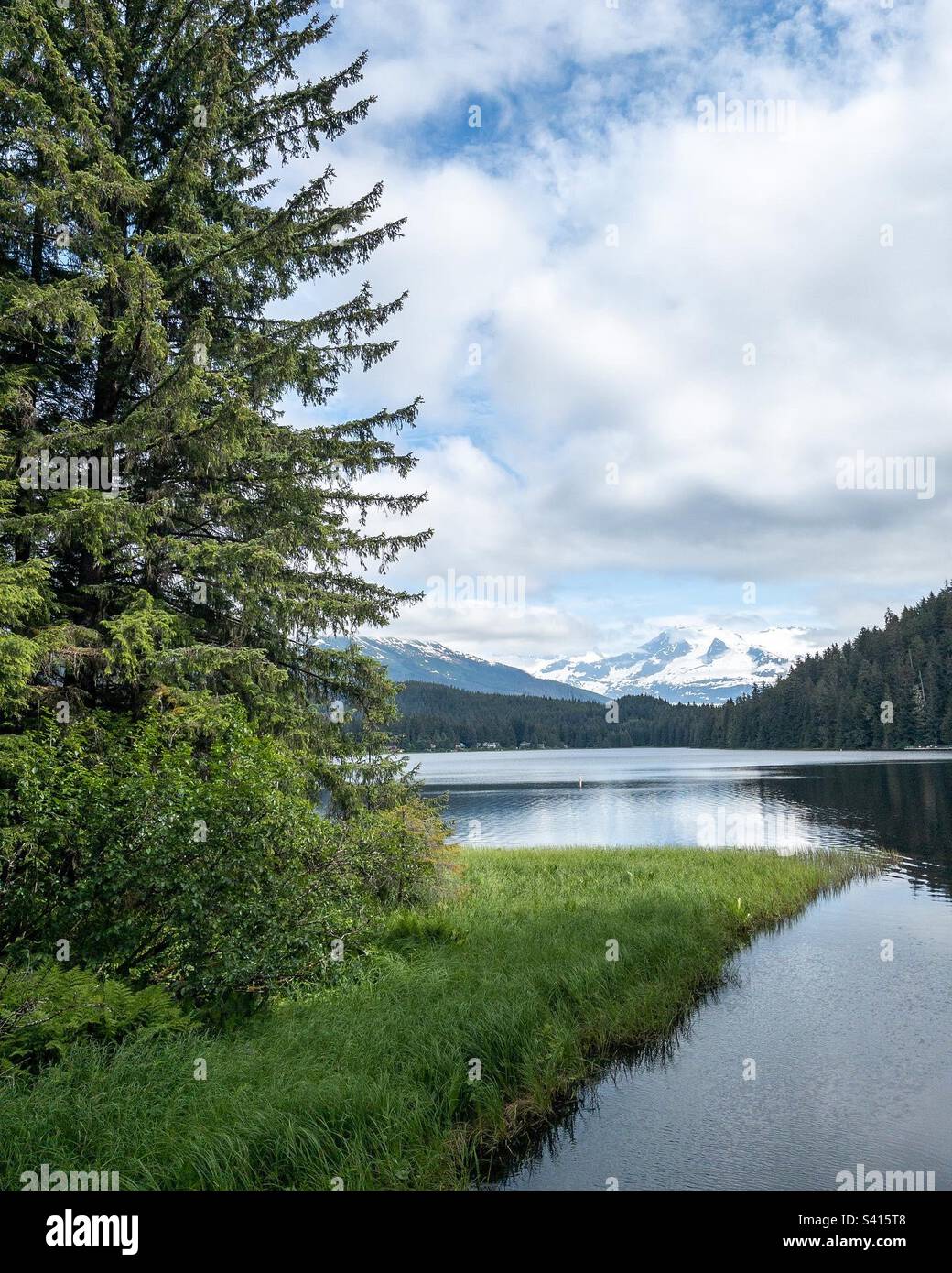 View off Auke Lake in Juneau, Alaska with snow topped mountains in ...