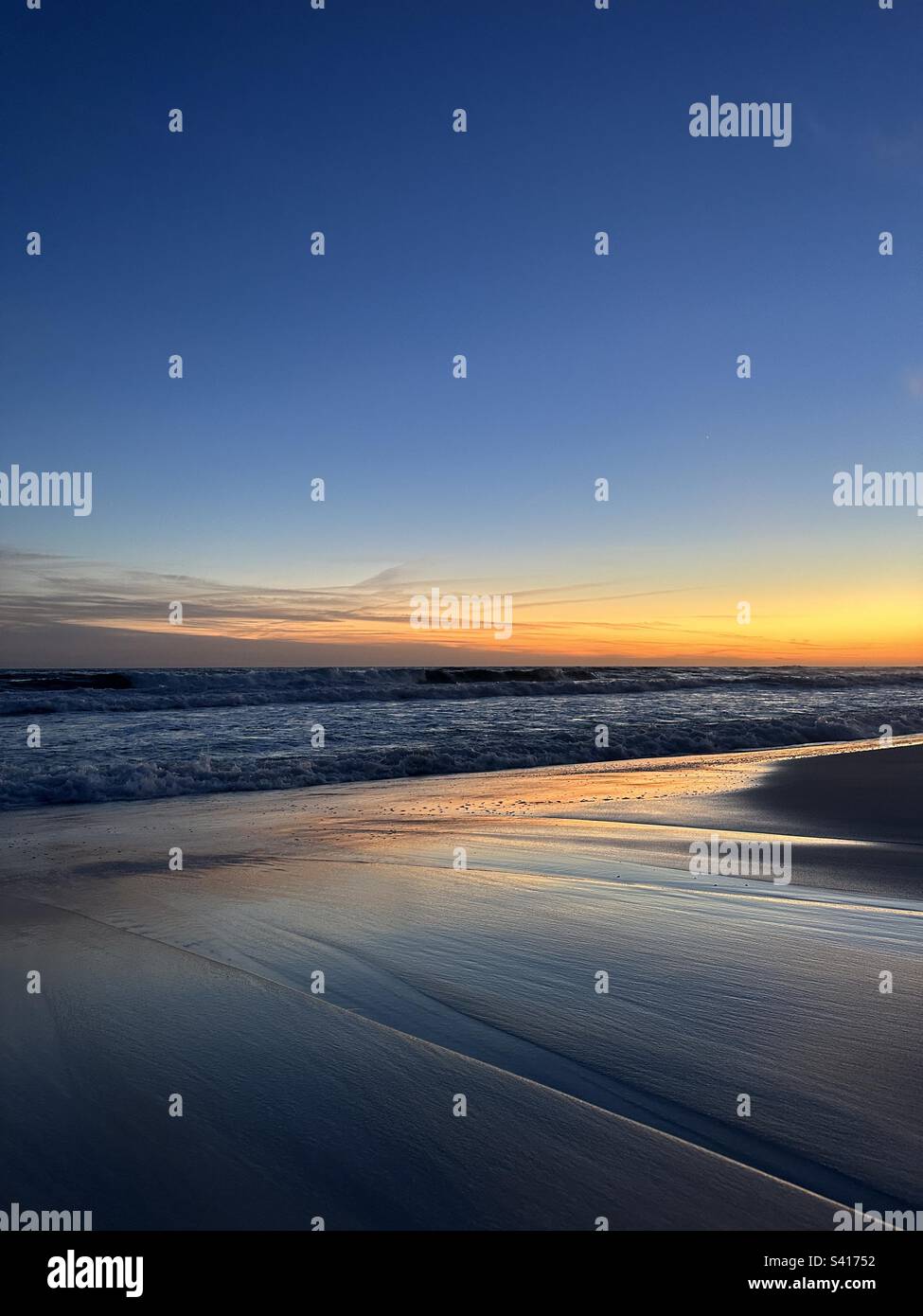 Blue hour beach sunset with sand textures Stock Photo - Alamy