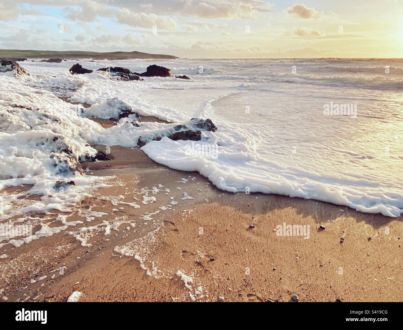 Foamy sea at high tide off the coast of Broad Beach, traeth llydan ...