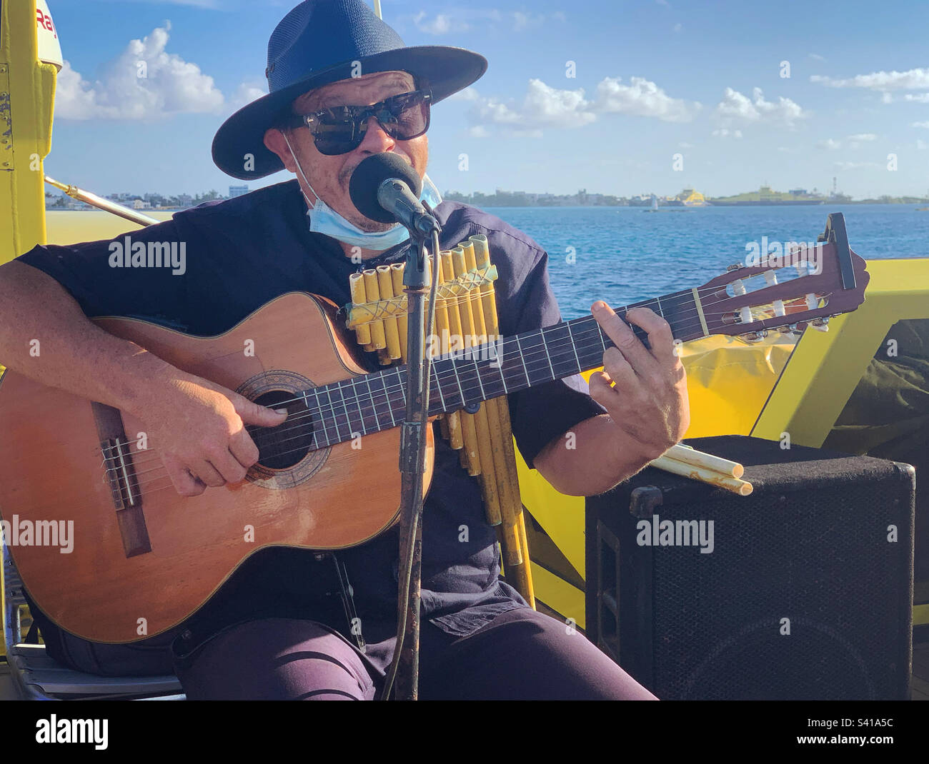Musician performing on an Ultramar ferry from Cancun to Isla Mujeres ...