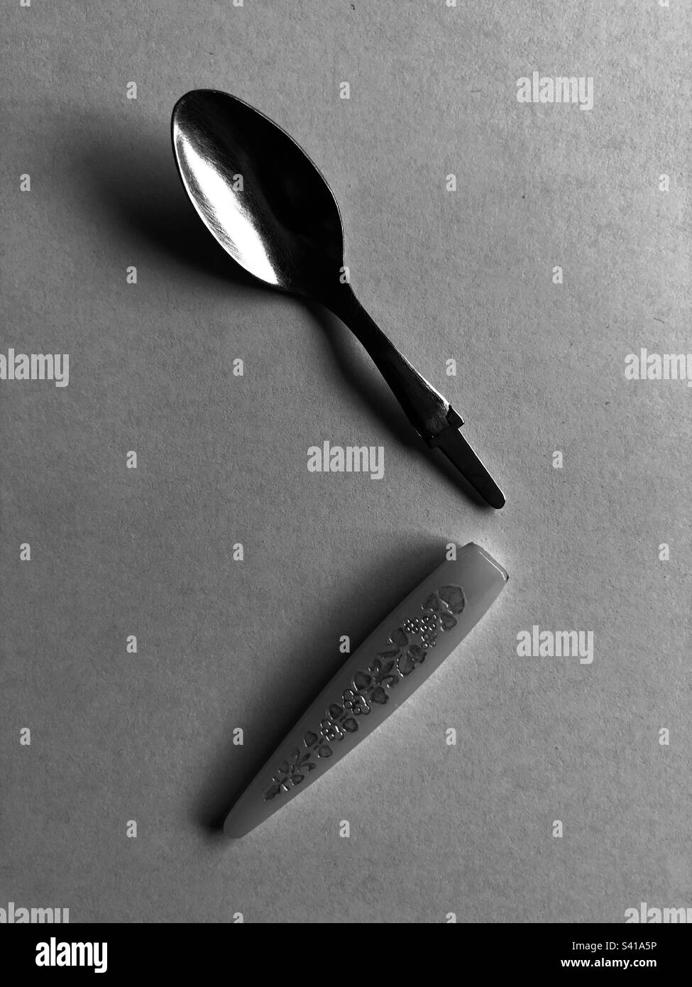 Black and white image of a broken teaspoon on white Stock Photo - Alamy