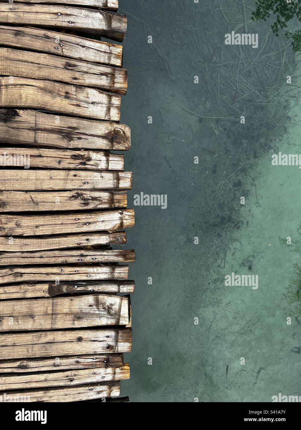Wooden walkway over clear water Stock Photo - Alamy