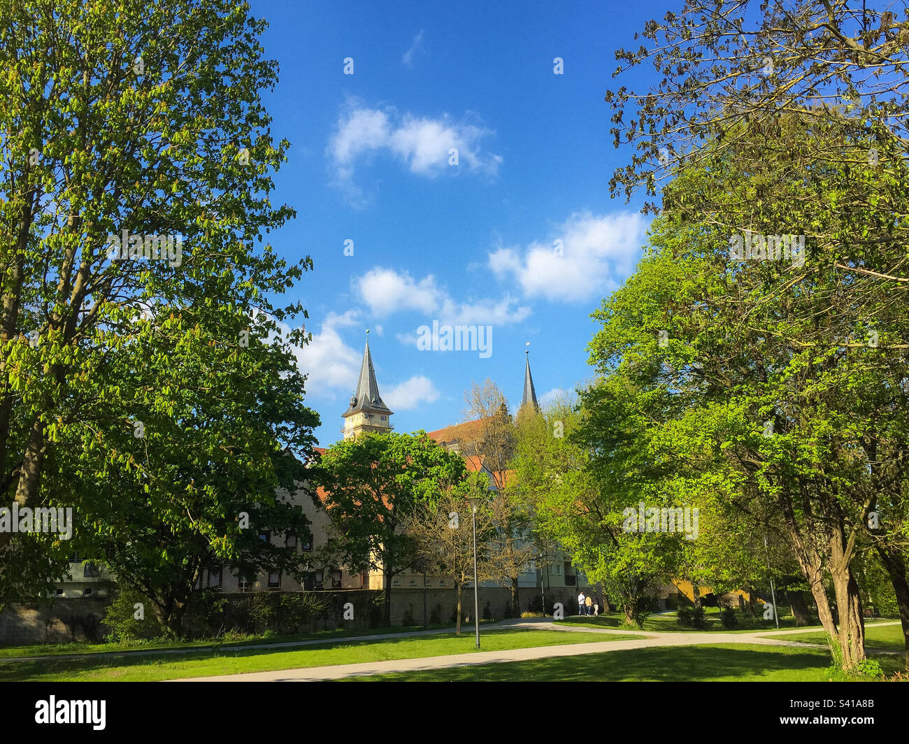 Church tower of Oehringen in Germany from a park Stock Photo - Alamy