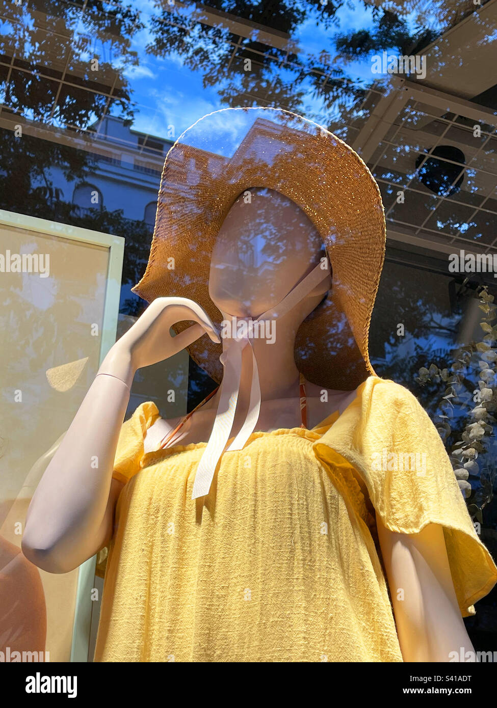 Mannequin wearing hat in a shop window Stock Photo - Alamy