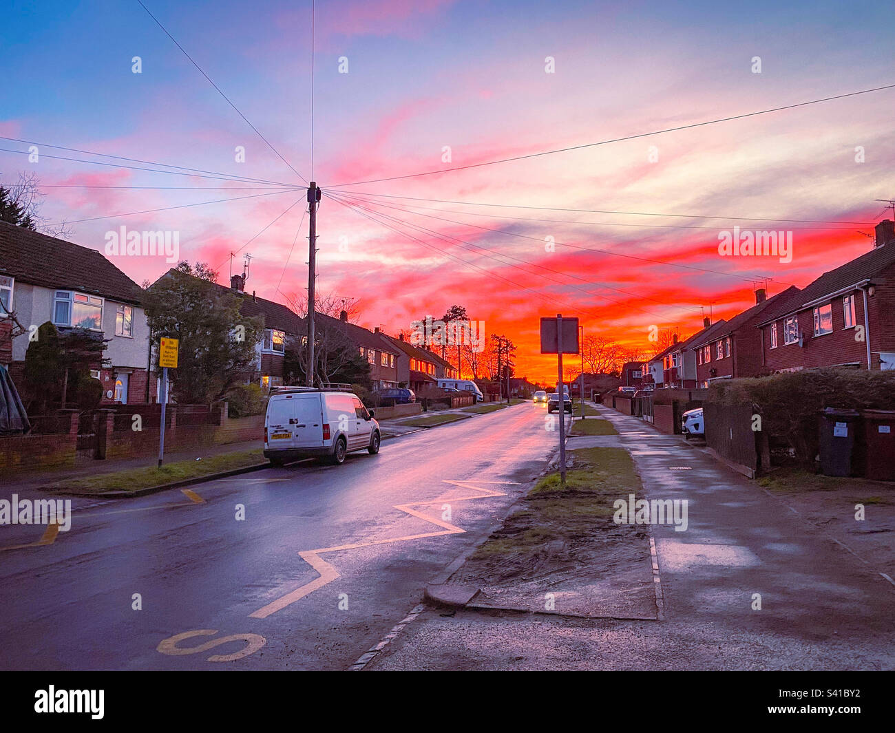 View down a residential street at sunset Stock Photo - Alamy