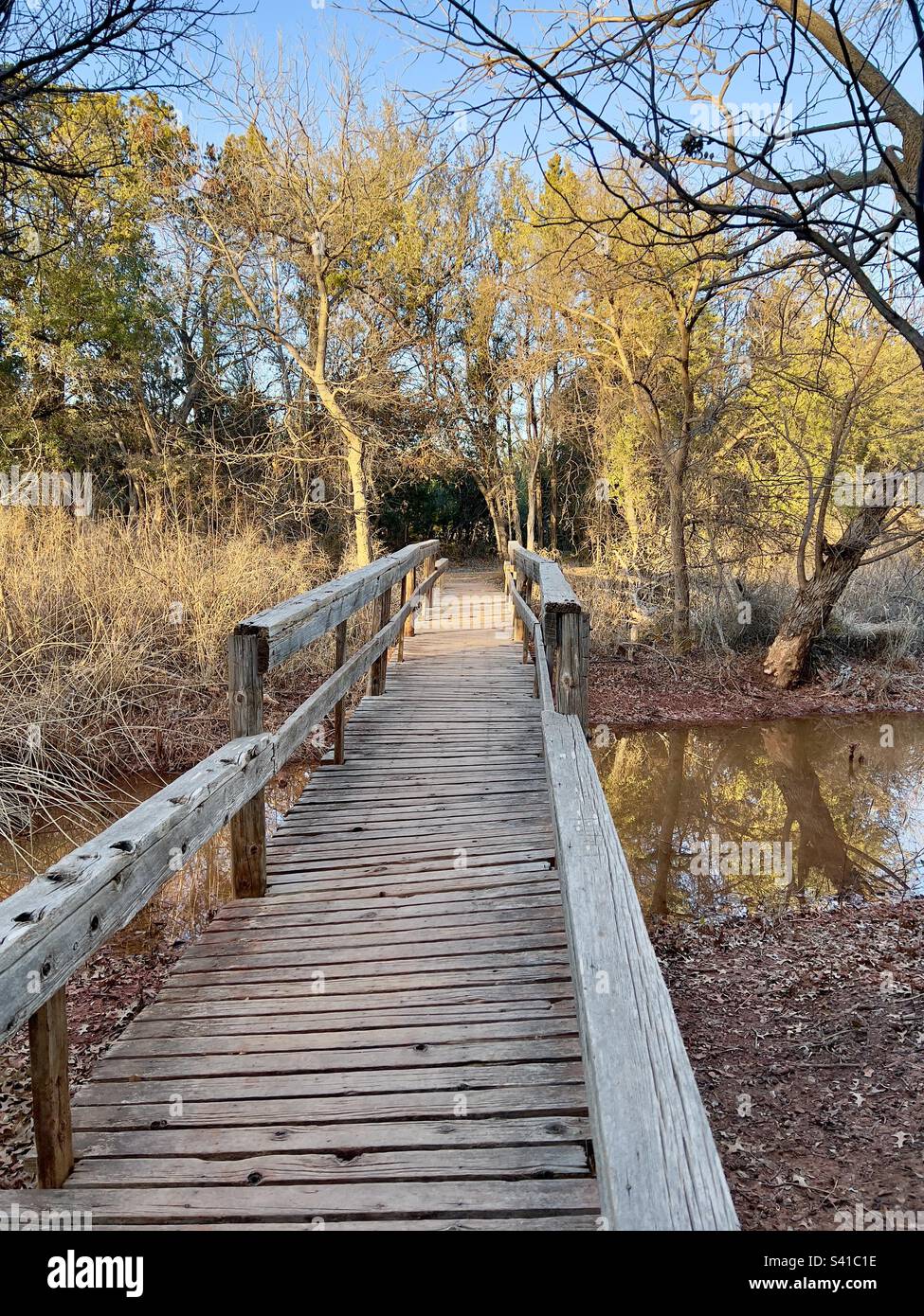 I Peaceful photo of a wooden cedar pedestrian bridge crossing over a ...