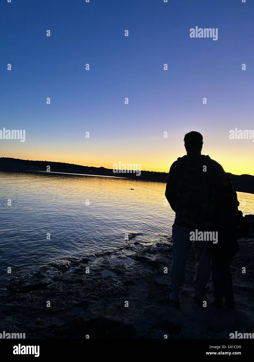 Boy watching the sunset at the lake hi-res stock photography and images ...