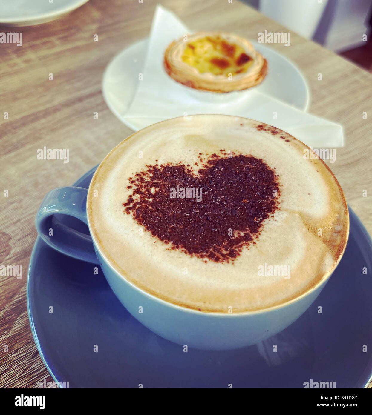 Coffee with heart in blue cup, pastry, pastel de nata Stock Photo - Alamy