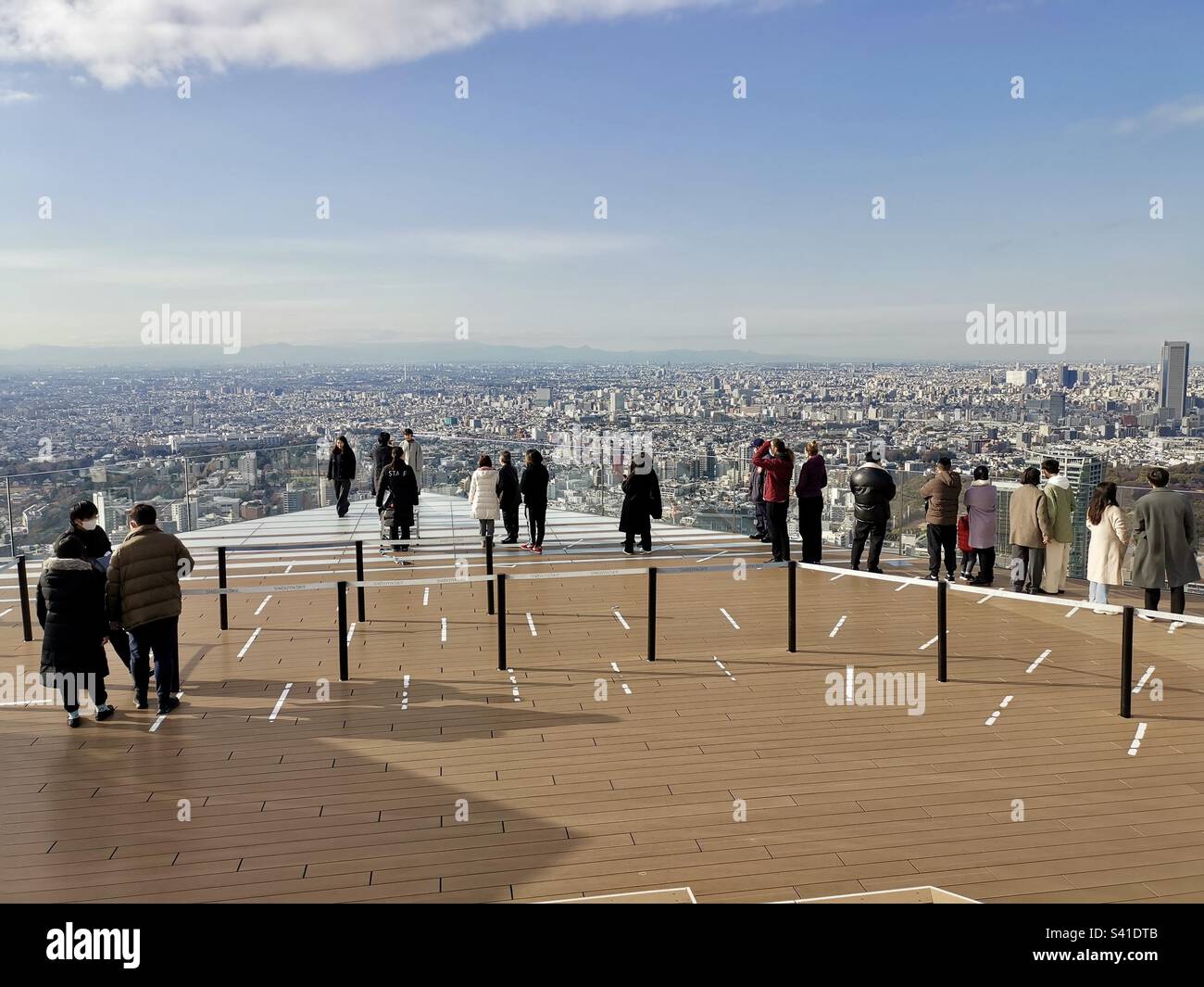 Tourists enjoying the views of Tokyo from the Shibuya Sky on top of the Shibuya Scramble square ...