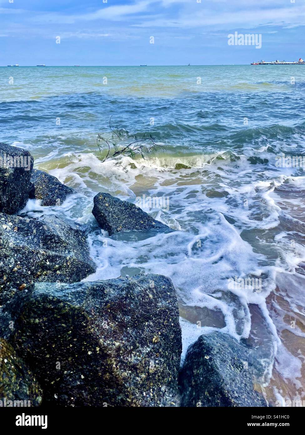 Relaxing on the rocks with cold sea water and blue sky at Pantai Puteri ...