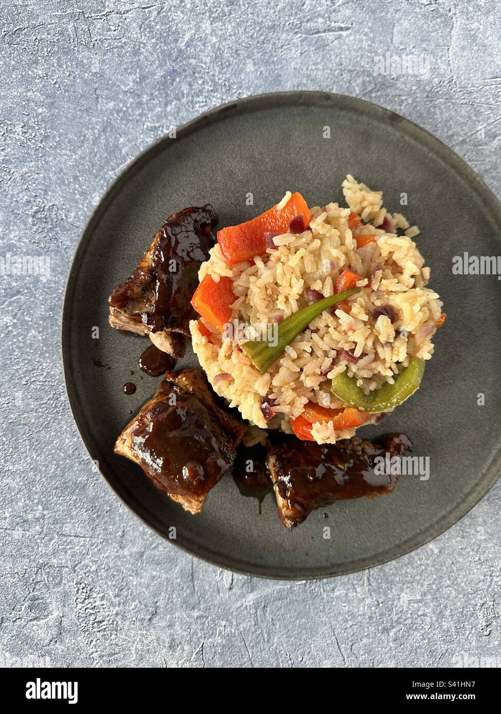 Pork barbecue with cajun rice Stock Photo - Alamy