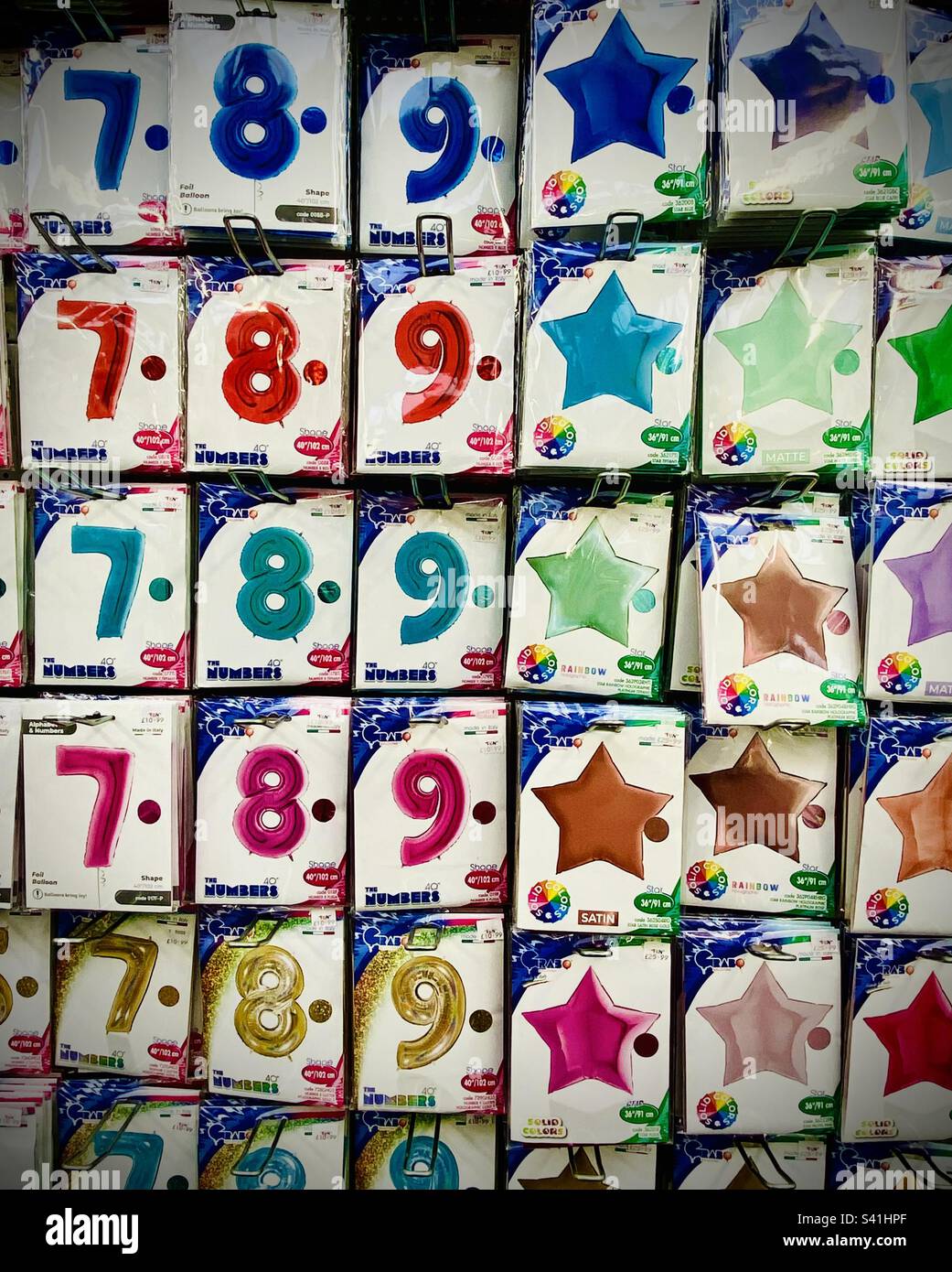 Balloons in the shape of numbers and stars for sale at a party shop in ...