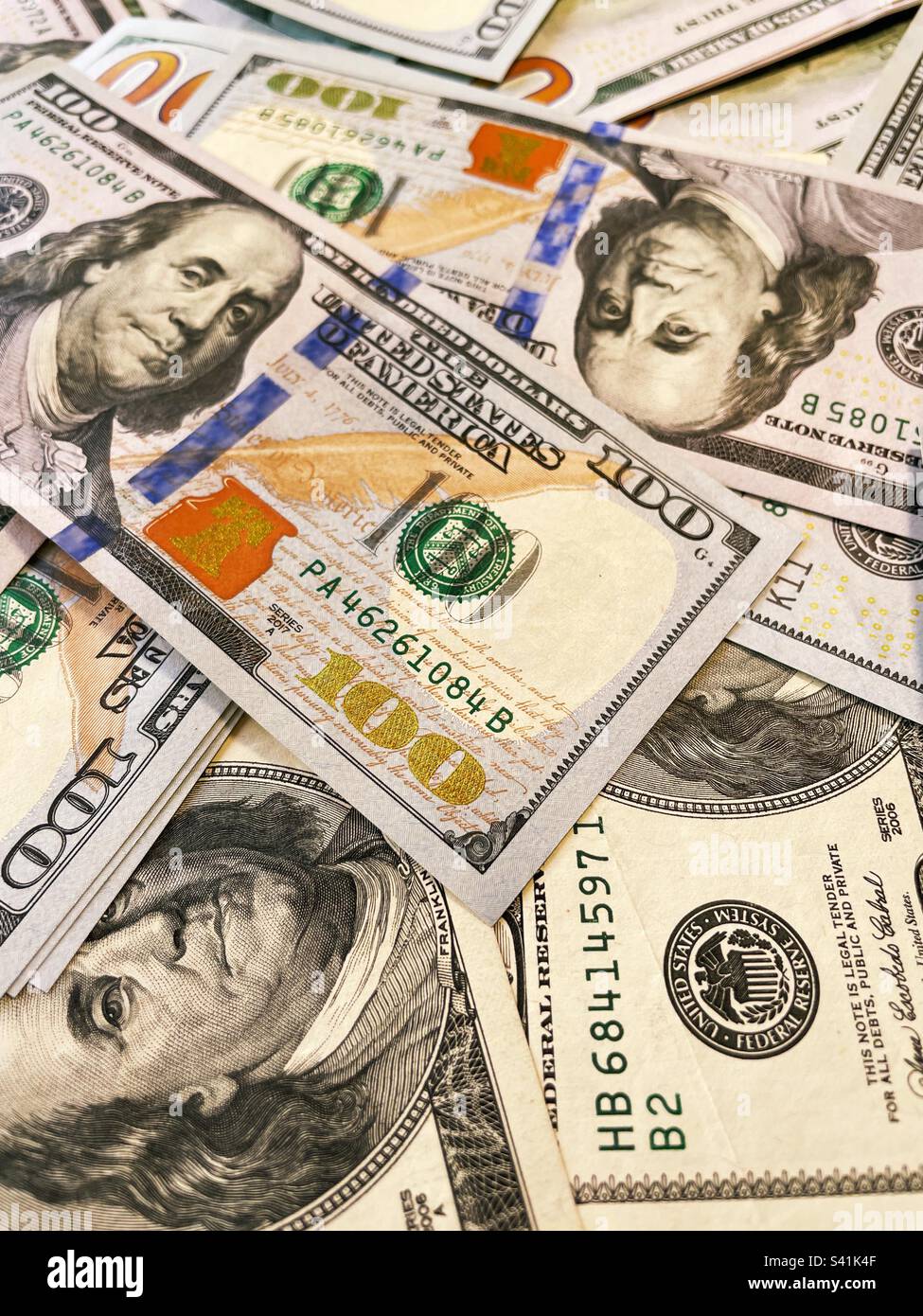 Close up of $100 bills showing the magnetic blue security stripe, 2023 ...