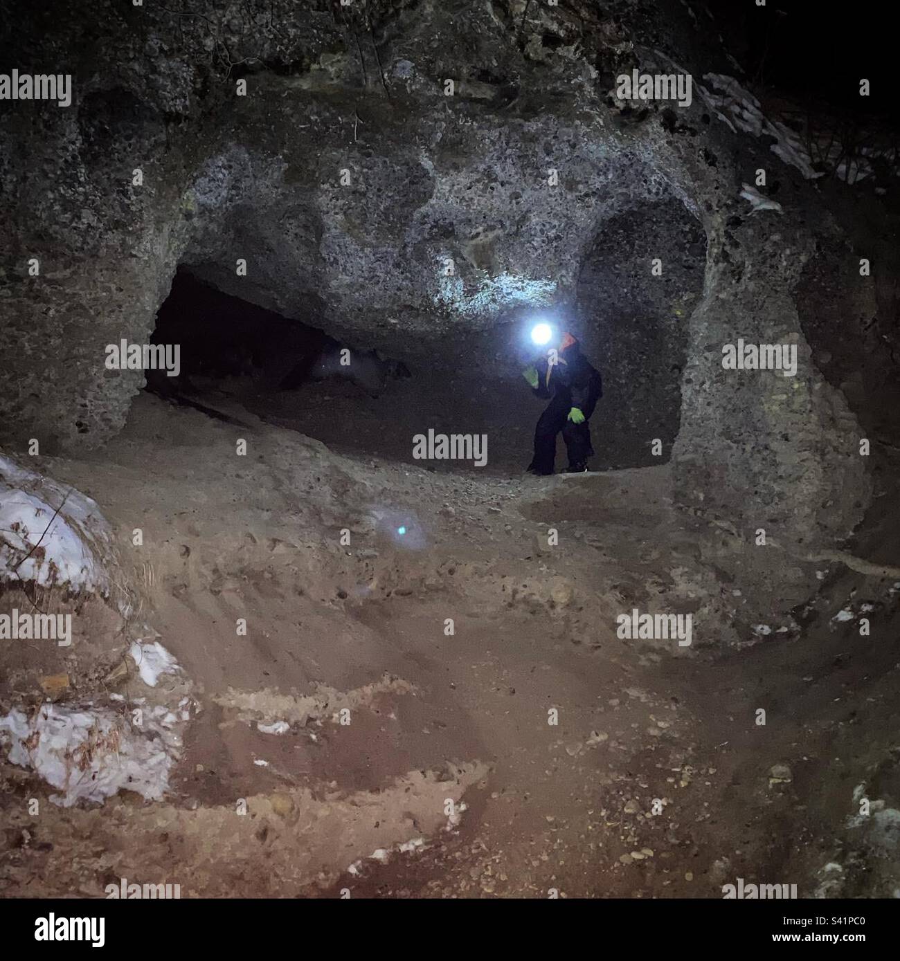 Little boy exploring cave at night Stock Photo - Alamy