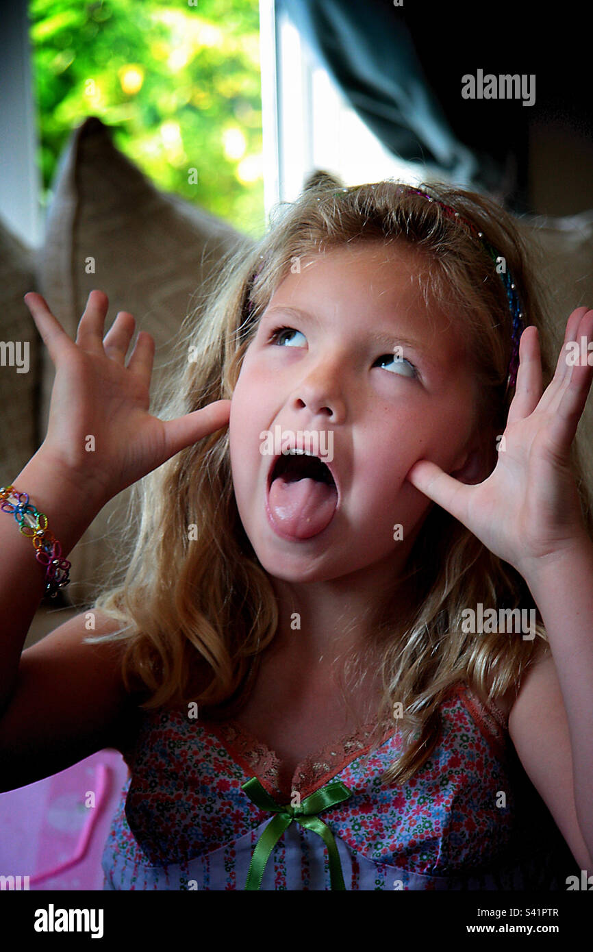 A young girls makes a funny face Stock Photo - Alamy